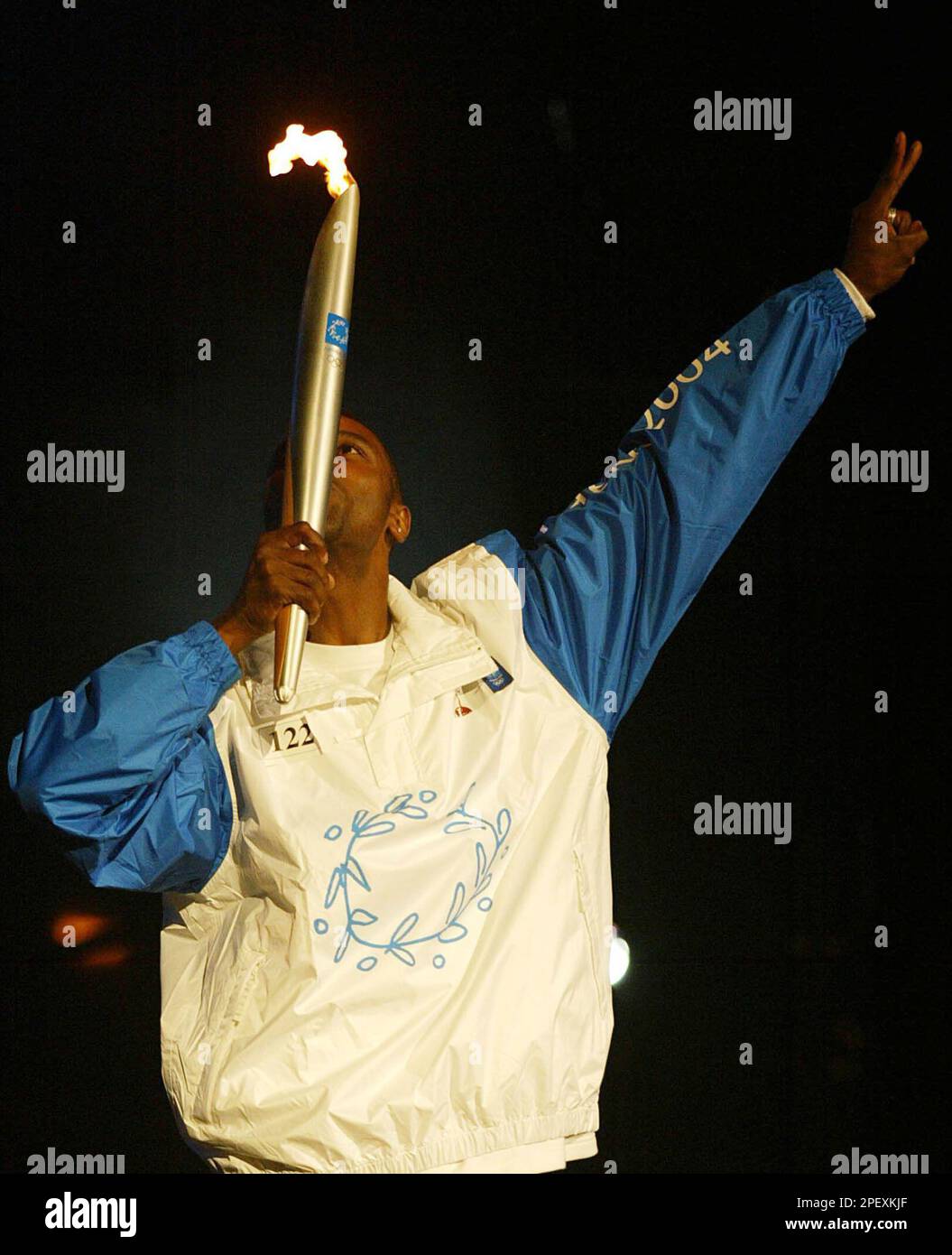 South African soccer icon Lucas Radebe makes a peace sign as he kisses ...