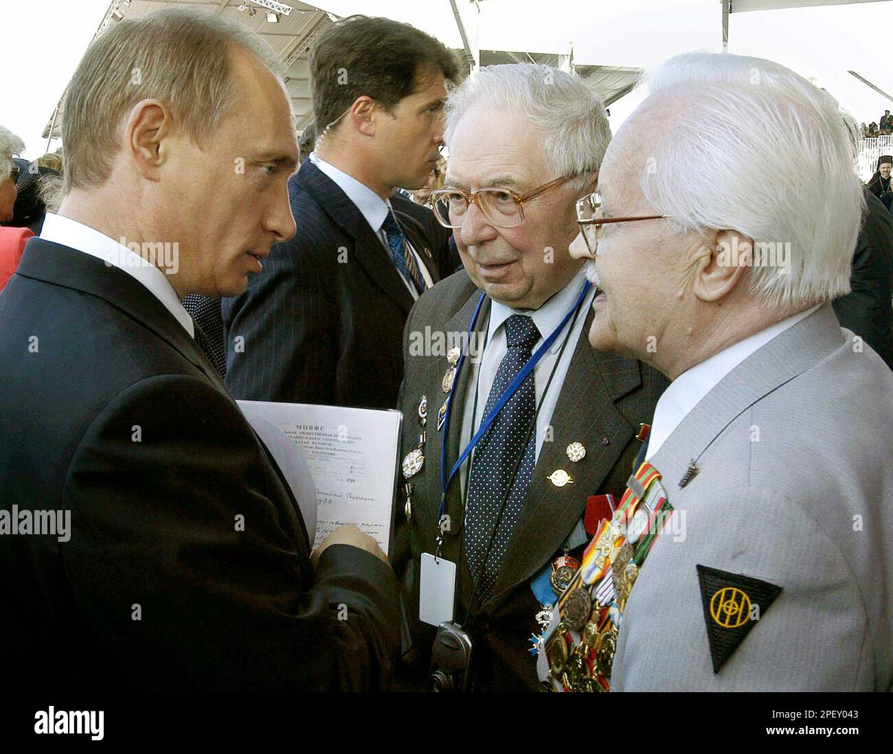 Russian President Vladimir Putin, left, speaks with his fellow ...