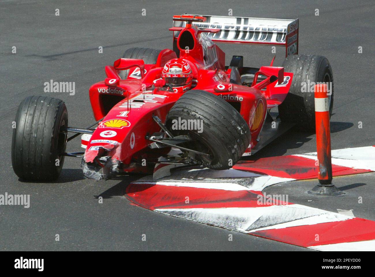 Michael Schumacher of Germany steers his damaged Ferrari towards the ...
