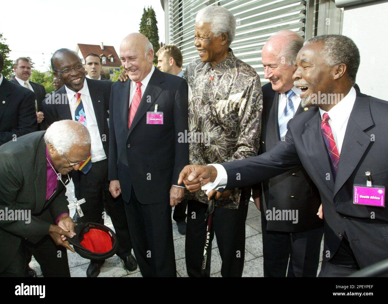 South African Arch Bishop Desmond Tutu, left, bows down as former South ...