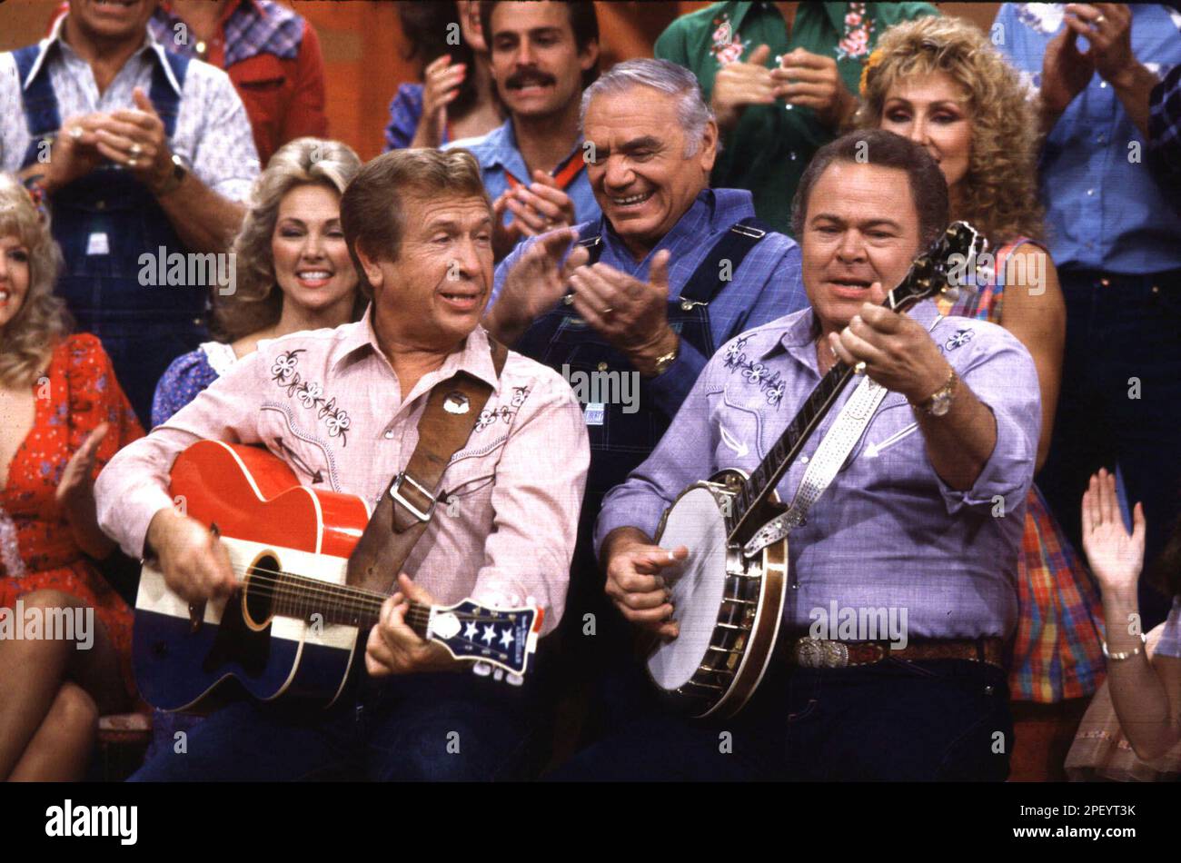 Co-hosts Buck Owens, left, and Roy Clark, right, perform with other cast members during a taping ...