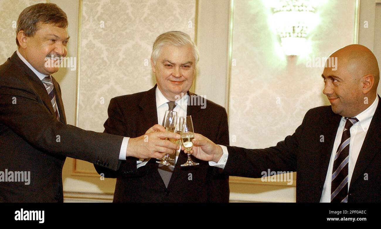 Dr. Sandor Csanyi, left, President and CEO of the OTP Bank, toasts with Lord Lamont of Lerwick ...