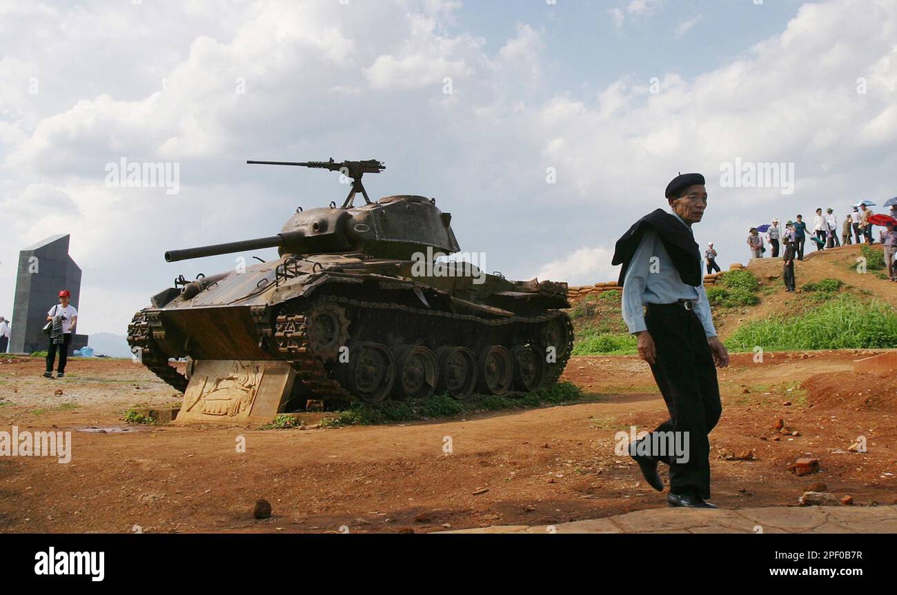 A Vietnamese tourist walks past a destroyed French tank during a visit ...