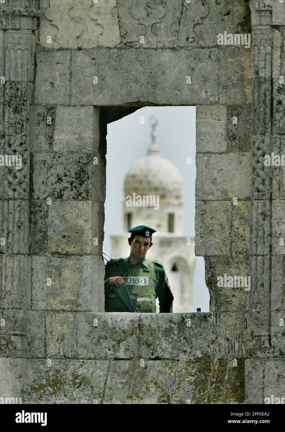 An Israeli border police officer stands guard in Damascus gate as the ...