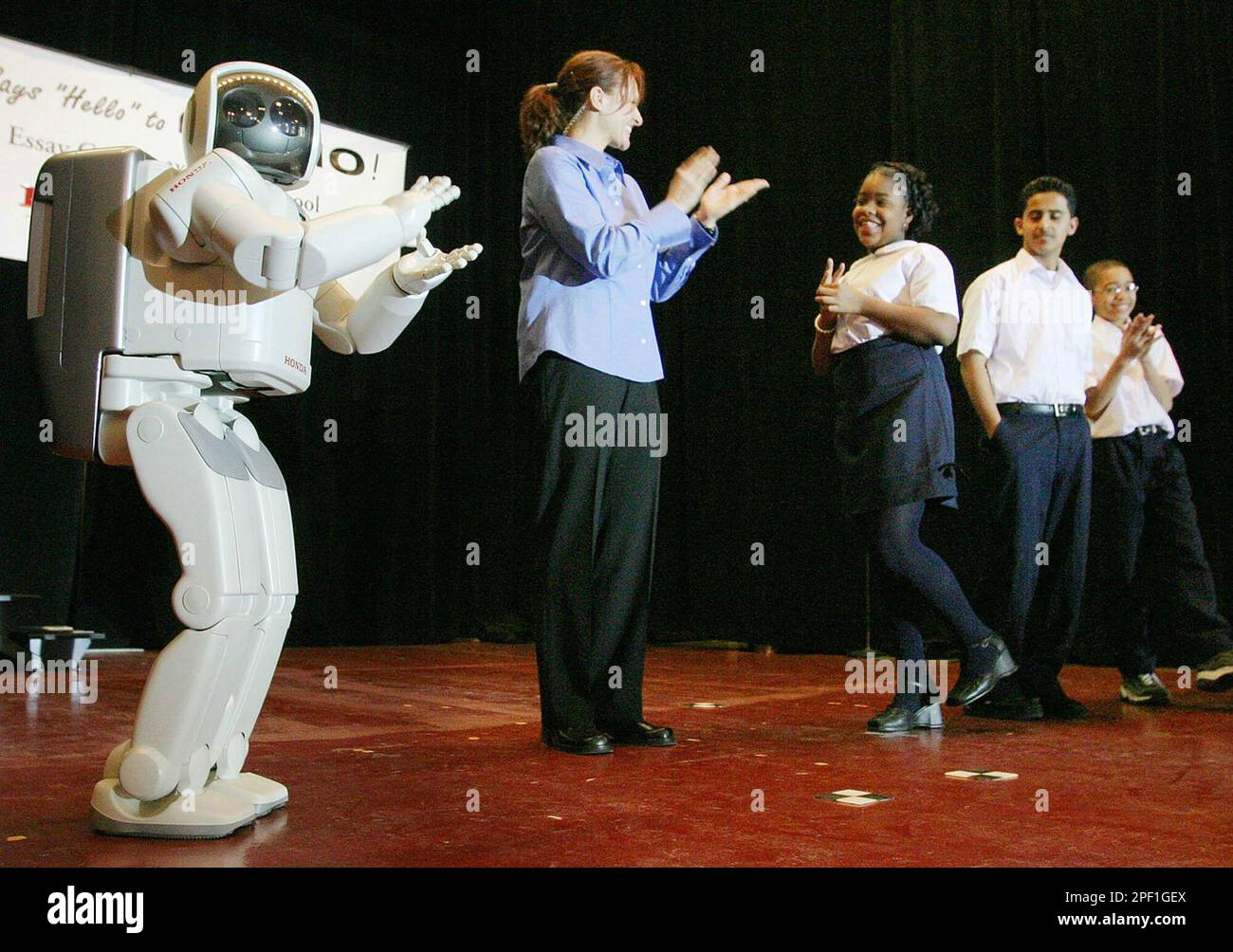 ASIMO, a four-foot humanoid robot, claps along with Suzanne Beguelin ...