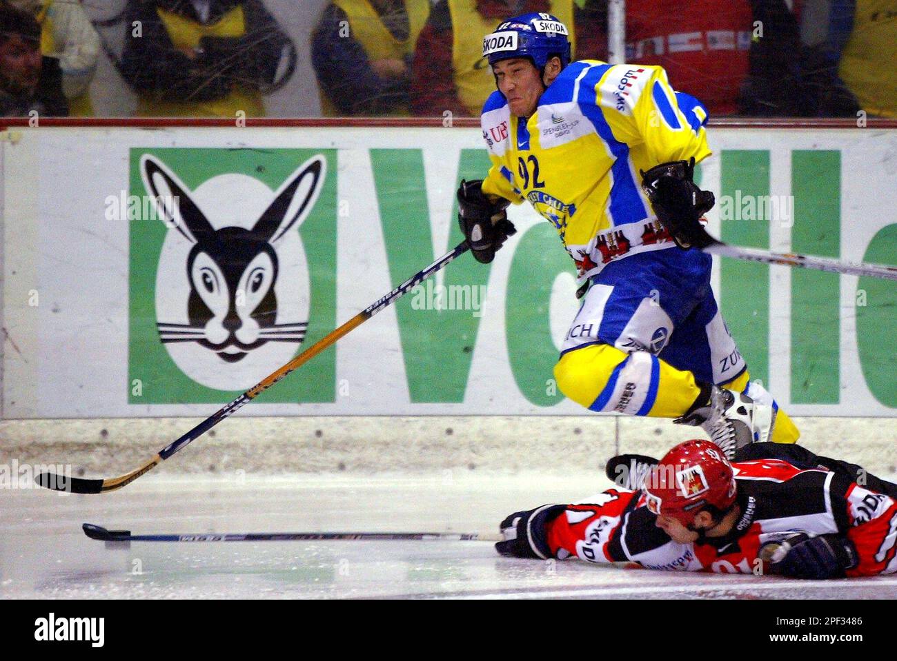 Team Canada's Jean-Guy Trudel, right, falls in front of Swiss team HC ...