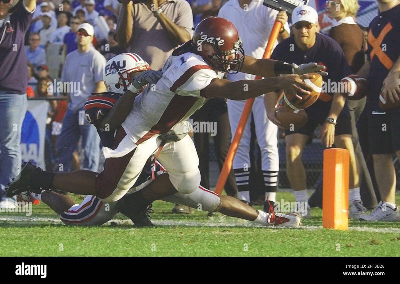Colgate quarterback Chris Brown (1) stretches to reach into the end ...