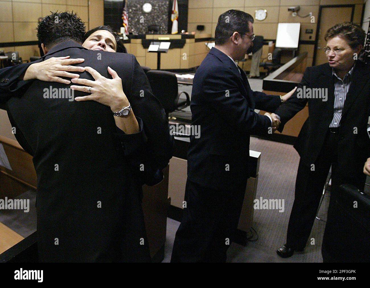Billy Negron, left, hugs his mother Maria Negron, second left, as his ...