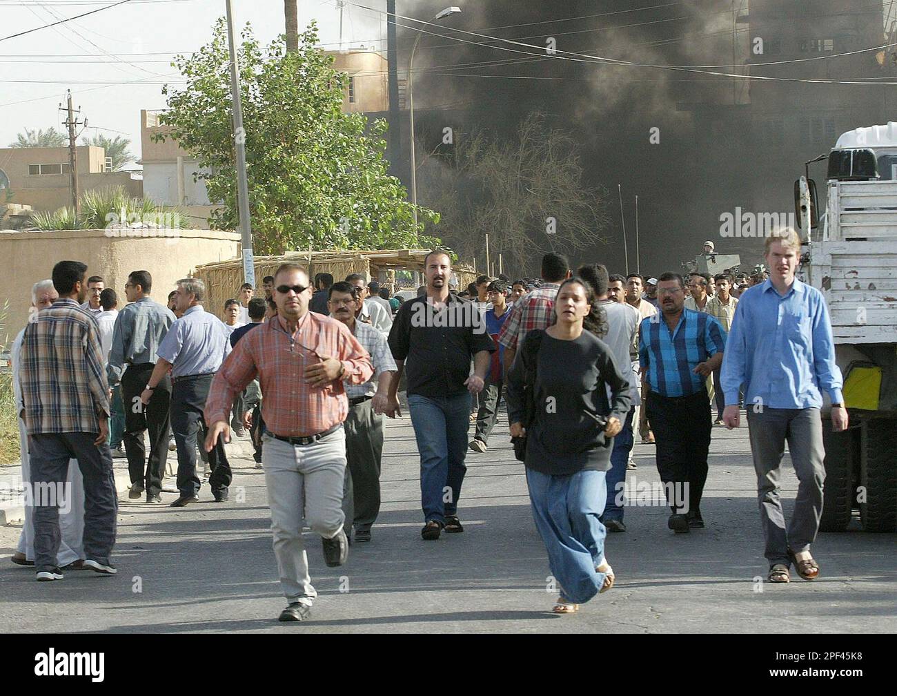 People run away after a suicide bomber rammed an ambulance packed with ...