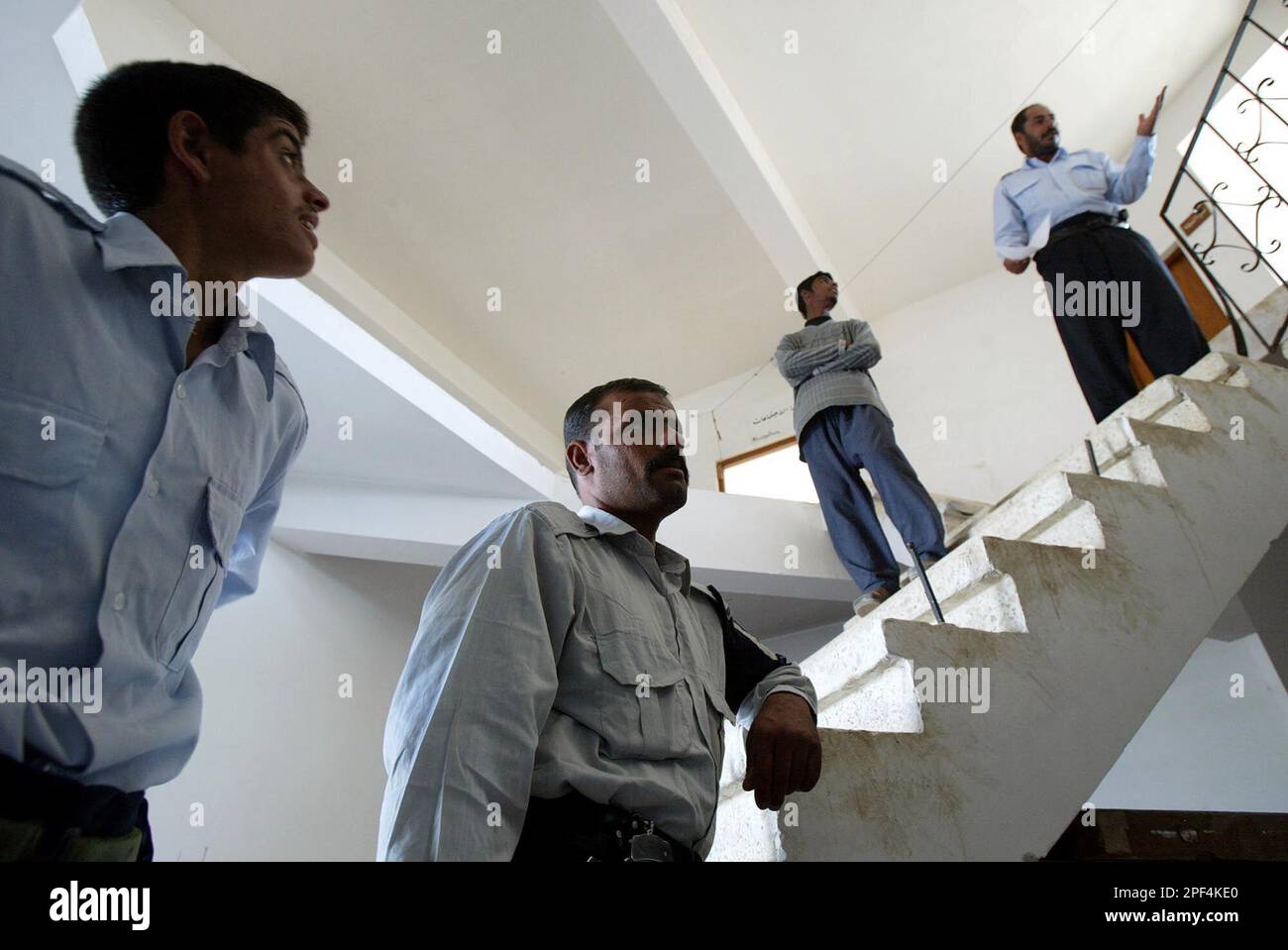 Iraqi police officers stand in the partially constructed building they ...