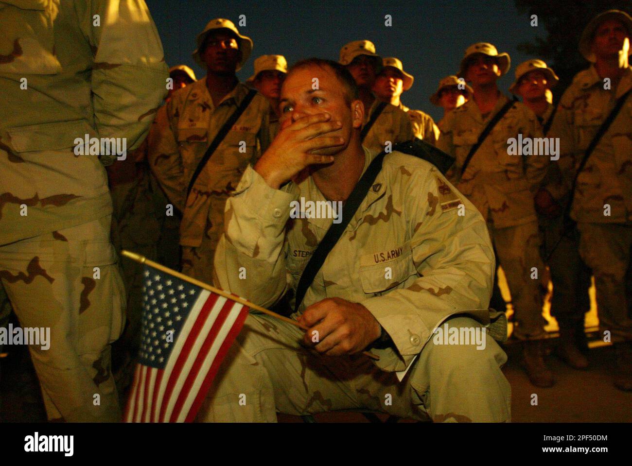 Sgt. First Class William Stephens holds an Ameican flag as he and ...