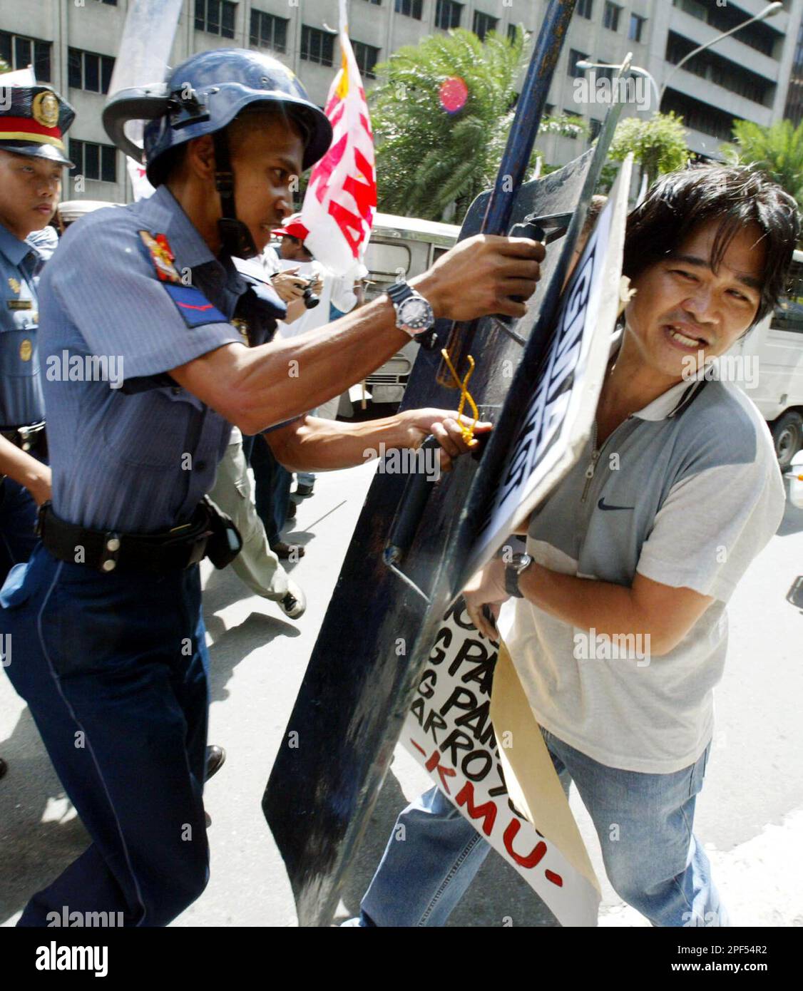 A riot police officer hits a protester with his shield during dispersal ...