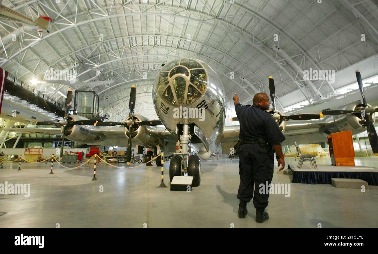 An unidentified security guard points to the cockpit of the Smithsonian ...