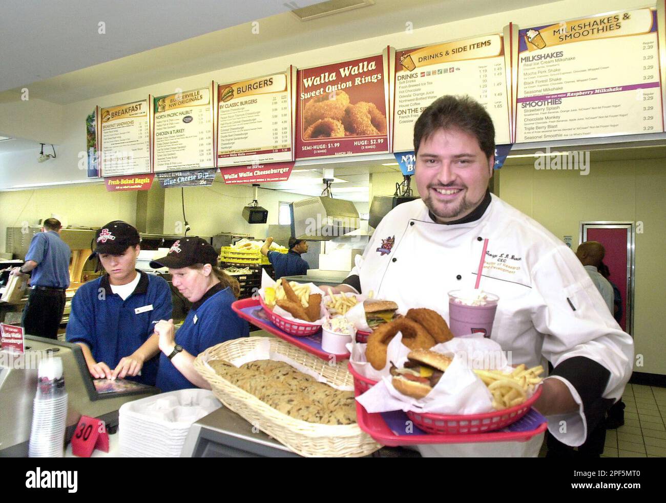 Burgerville executive chef George Brown holds several trays of food ...