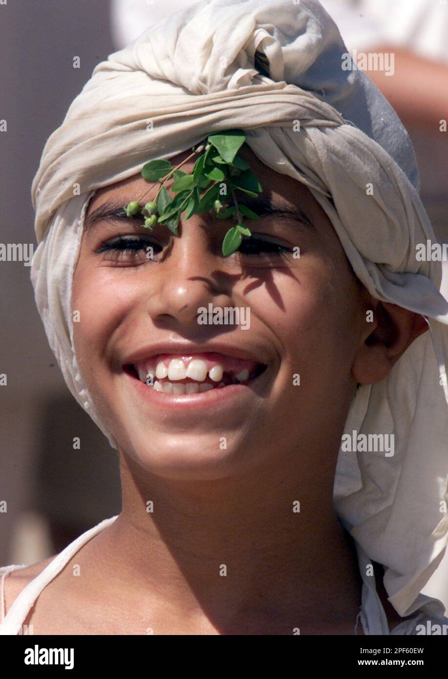 A young Iraqi Sabaean Mandean wears an ornimental symbol of peace ...
