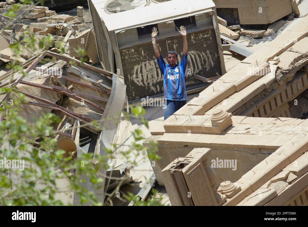 An Iraqi man who tried to loot goods from the ruins of one of the ...