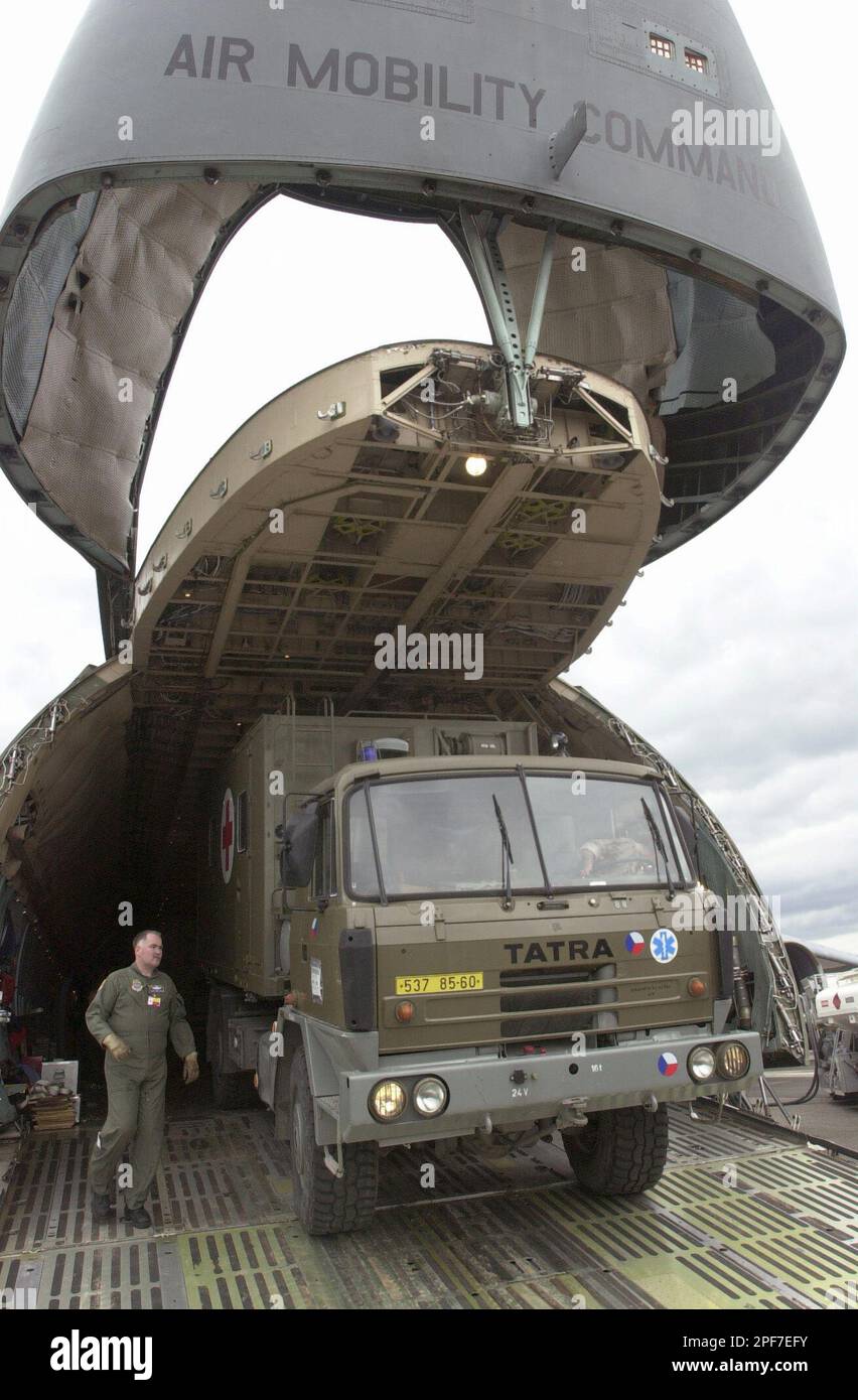A U.S. crewman checks loading of a Czech army truck into a USAF ...