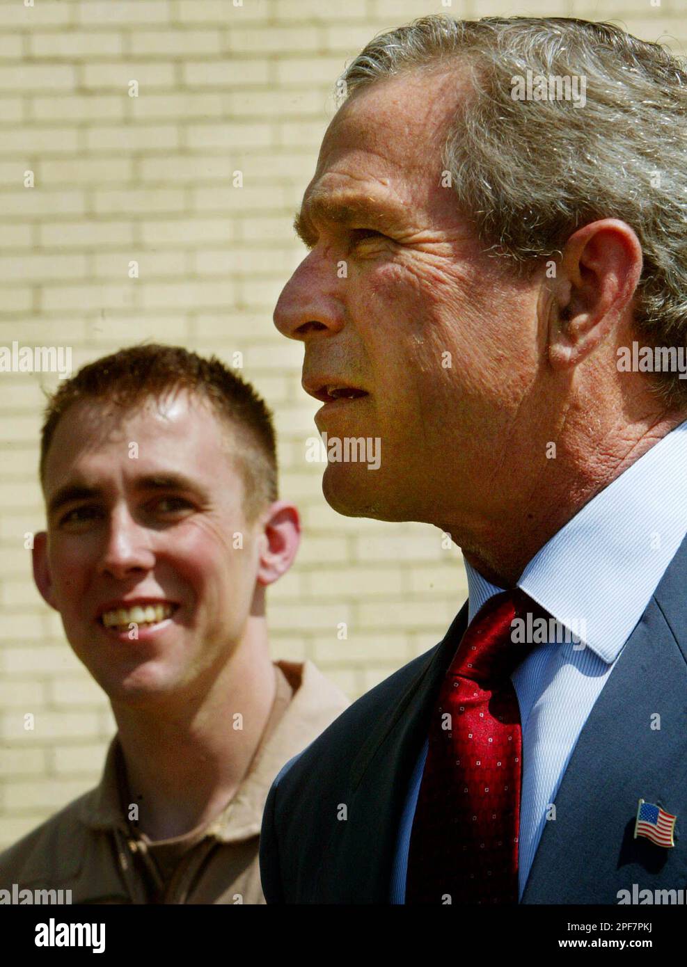 Chief Warrant Officer Ronald D. Young Jr., left, a former POW, listens ...