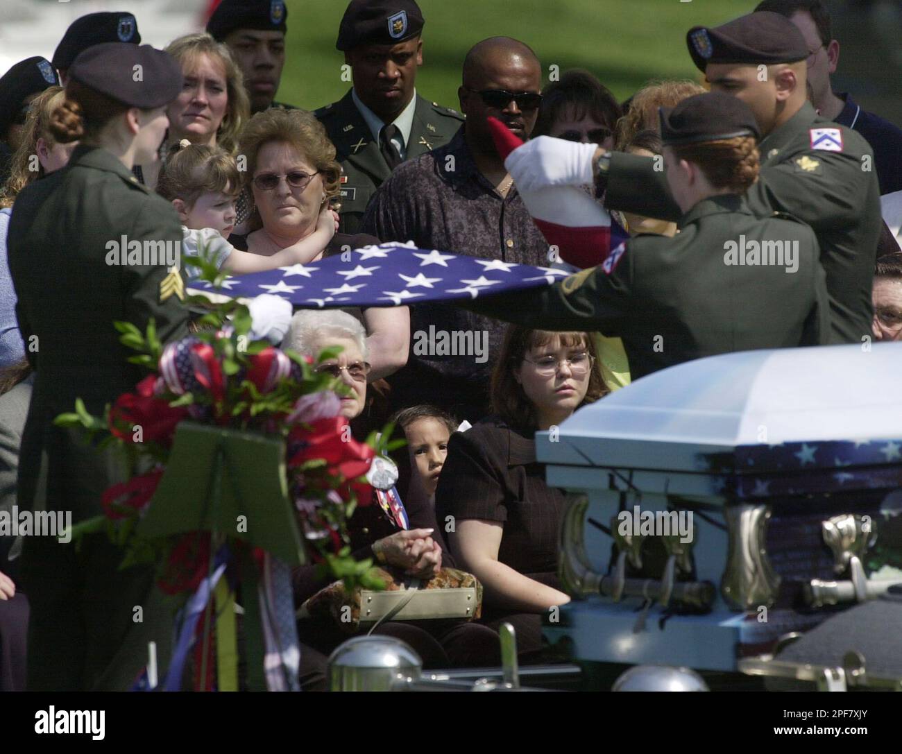 Arlene Walters, seated partially obscured, mother of Army Sgt. Donald ...