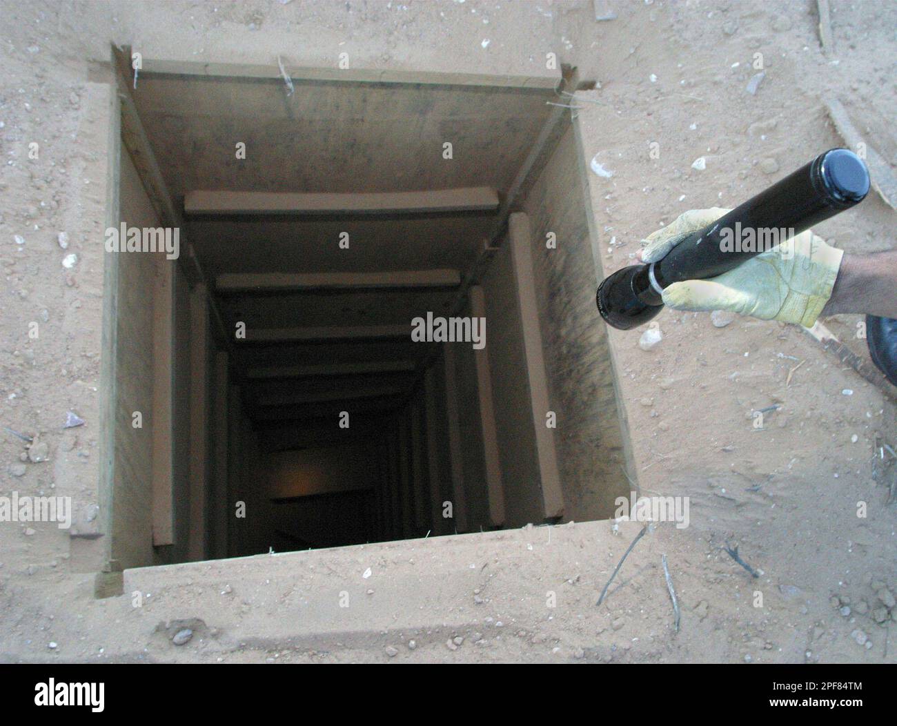 Sandoval County Sheriff John Paul Trujillo points a flashlight down a A ...