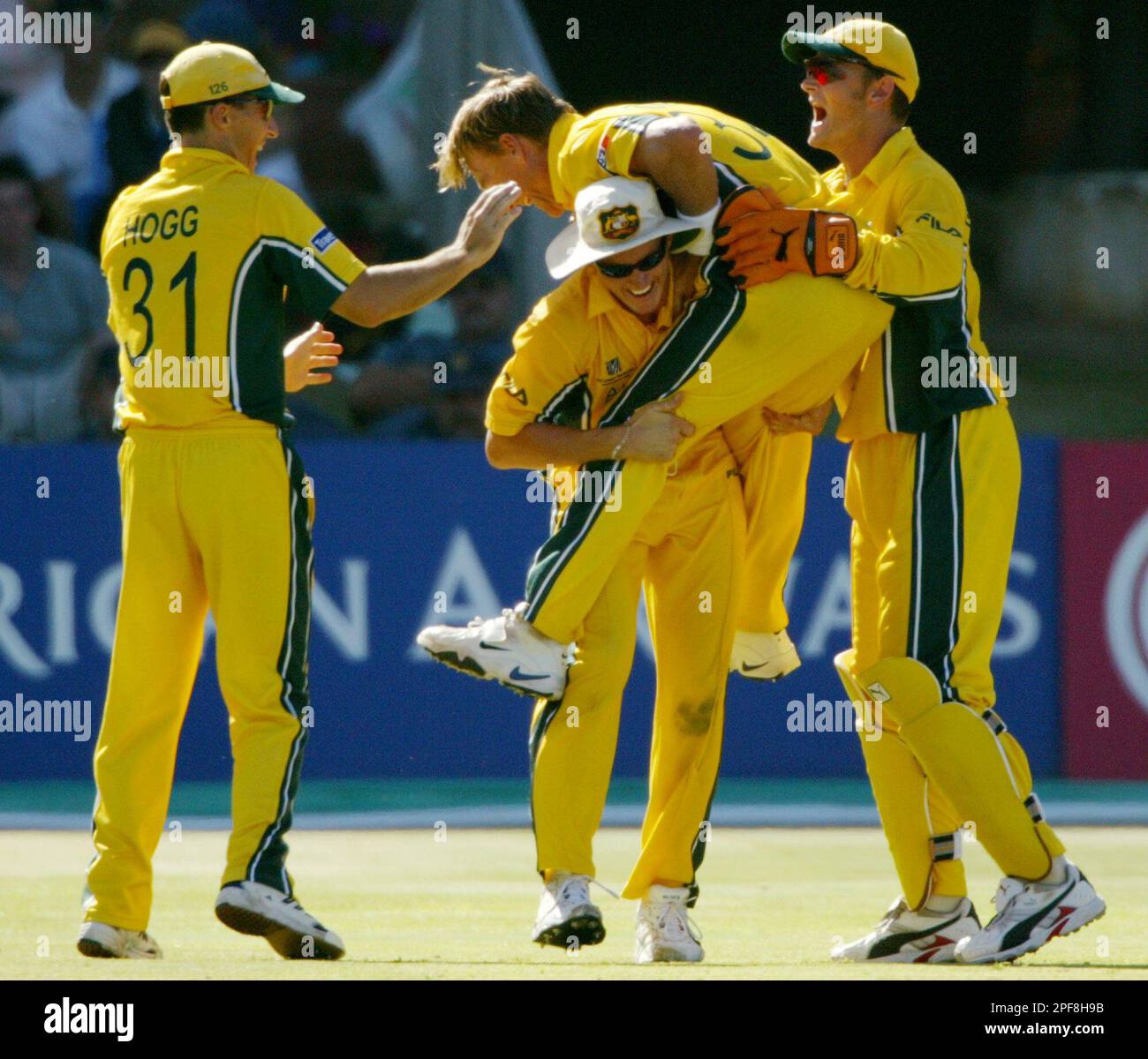 Australian bowler Andy Bichel, second from right, is lifted off his ...