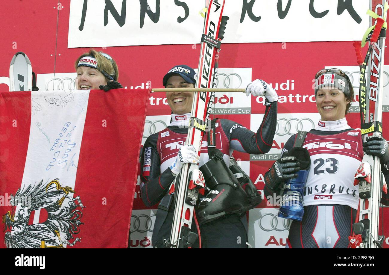 Winner Michaela Dorfmeister from Austria, center, holds the Austrian ...
