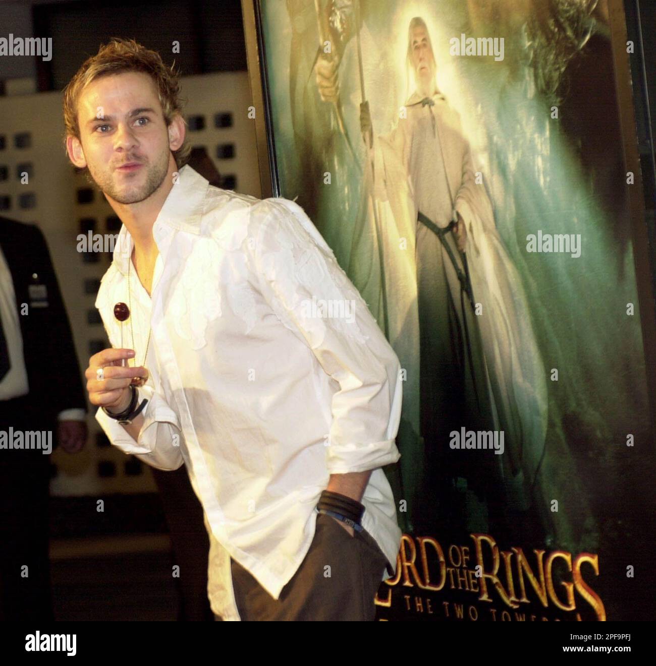 Actor Dominic Monaghan looks down the red carpet to see who is ...