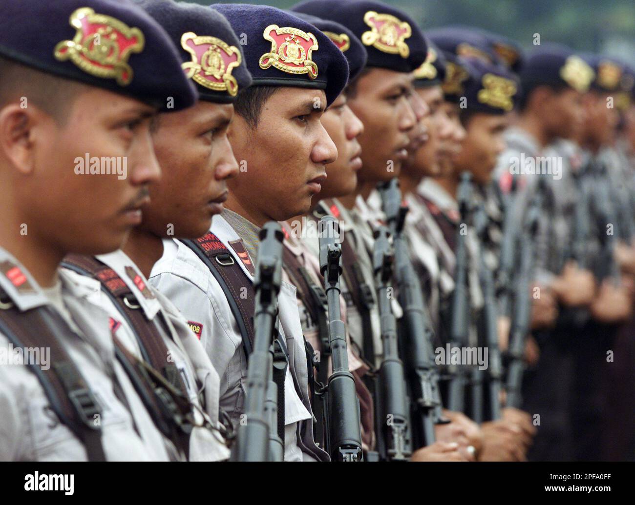 Indonesian police officers armed with automatic rifles line up during a show of force at the ...