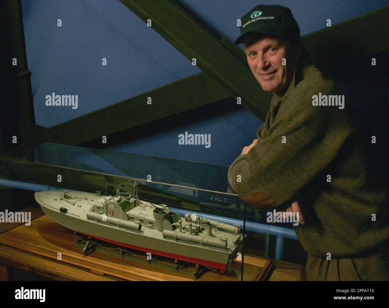 Explorer Robert Ballard poses next to a model of a World War II era PT ...