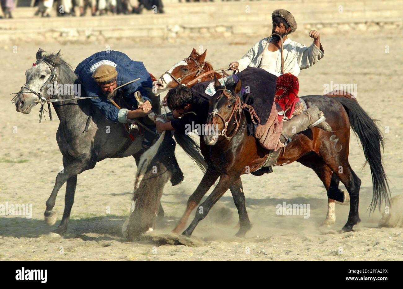 Afghans play buzkashi in Kabul, Friday, Nov. 22, 2002. Buzkashi, or ...