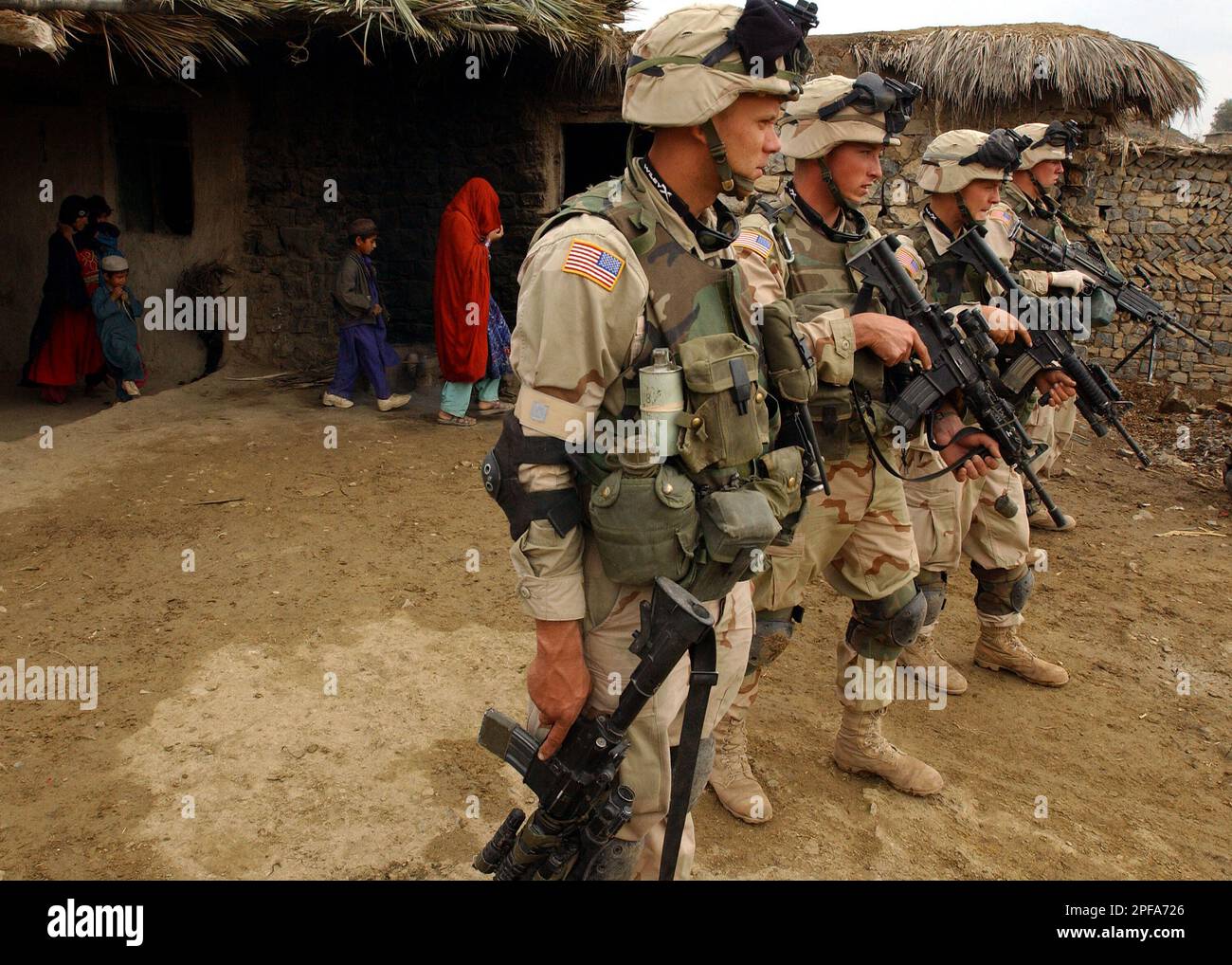 Soldiers from the U.S. Army 82nd Airborne Division turn their backs so ...