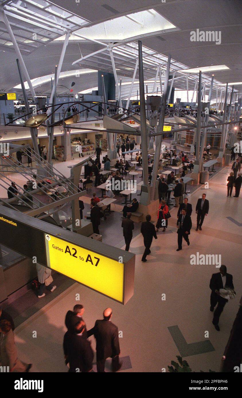 Airline passengers walk through the new Terminal 4, a $1.4 billion air ...