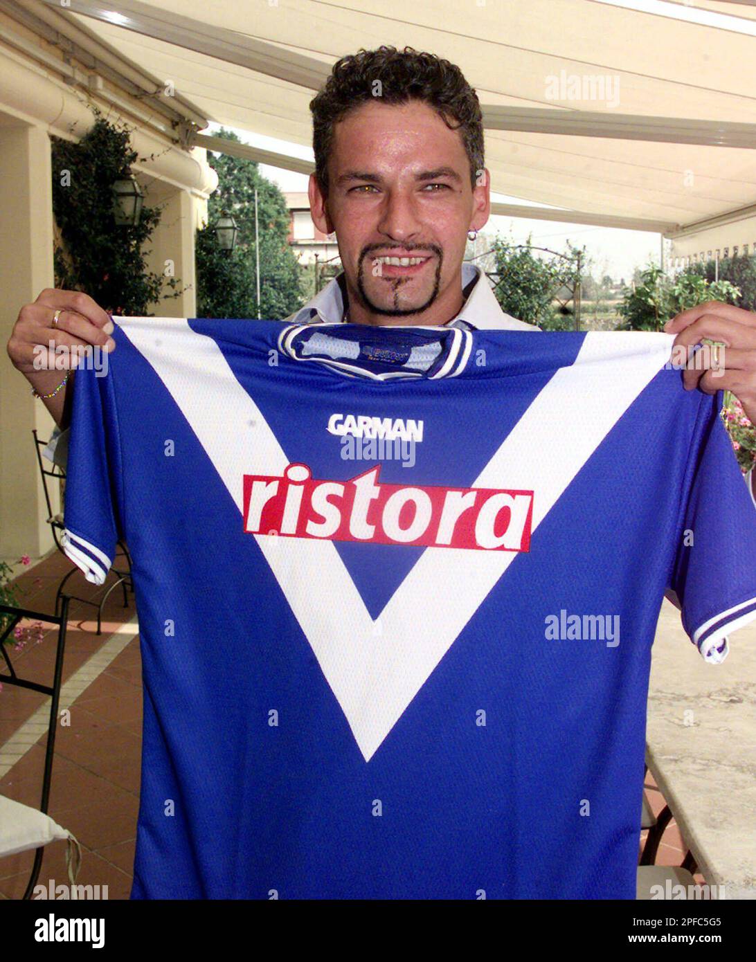 Soccer star Roberto Baggio shows the jersey of his new team, Brescia ...