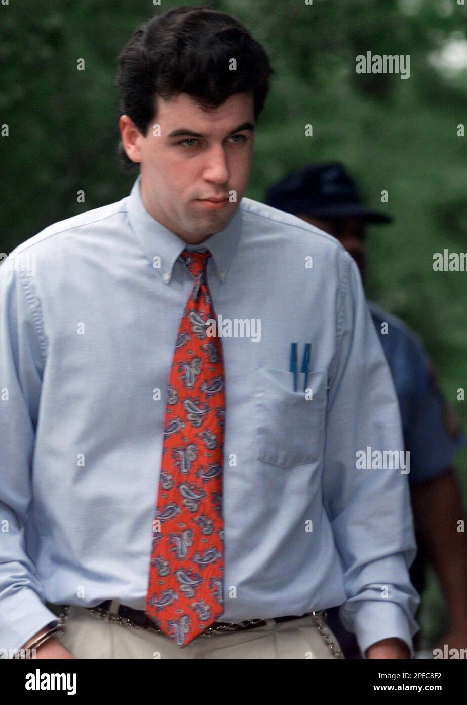 Daniel Starkey, his arms manacled at the waist, walks into Kent County ...