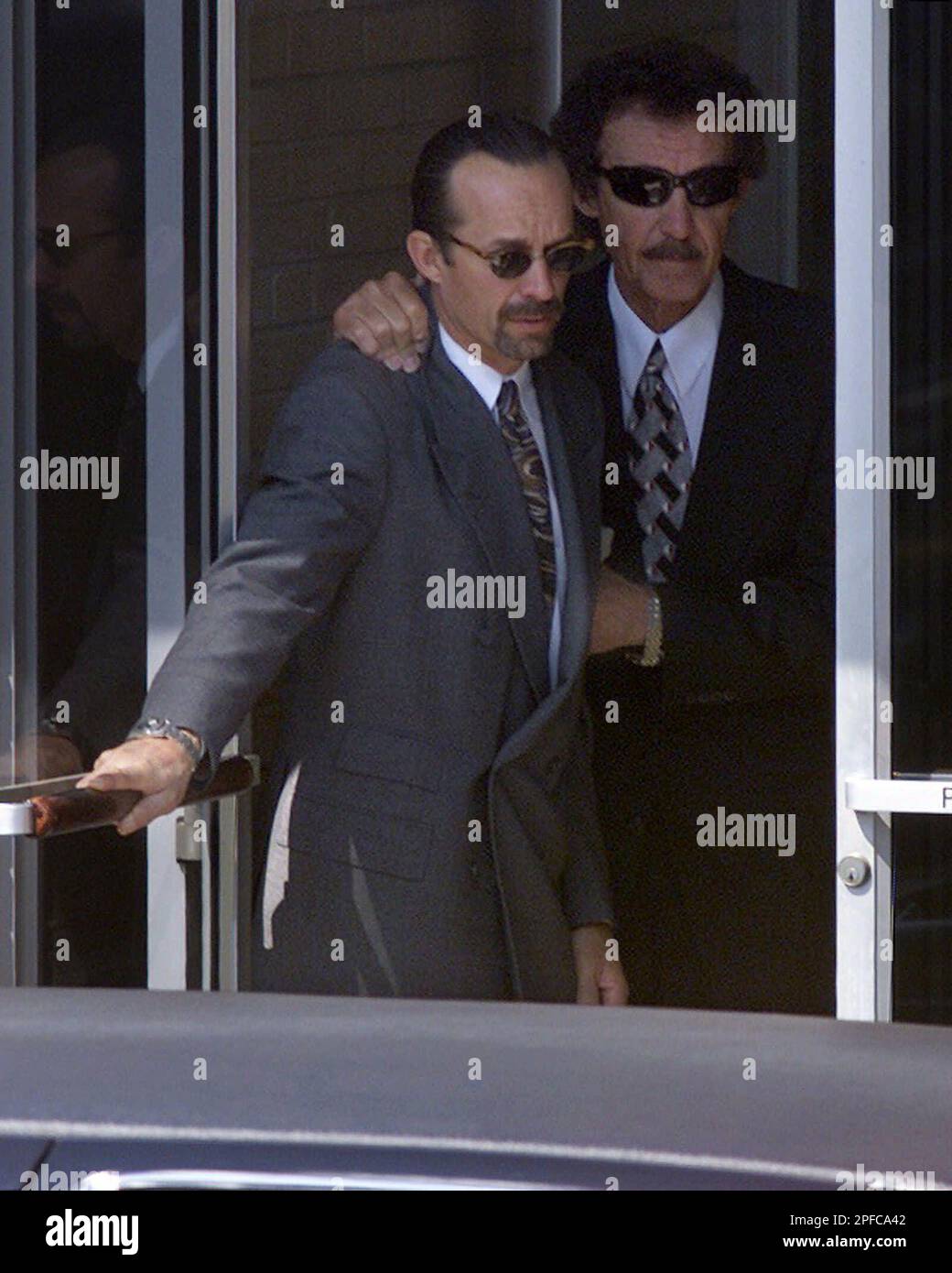 Kyle Petty, left, is comforted by his father, Richard Petty, as the two ...