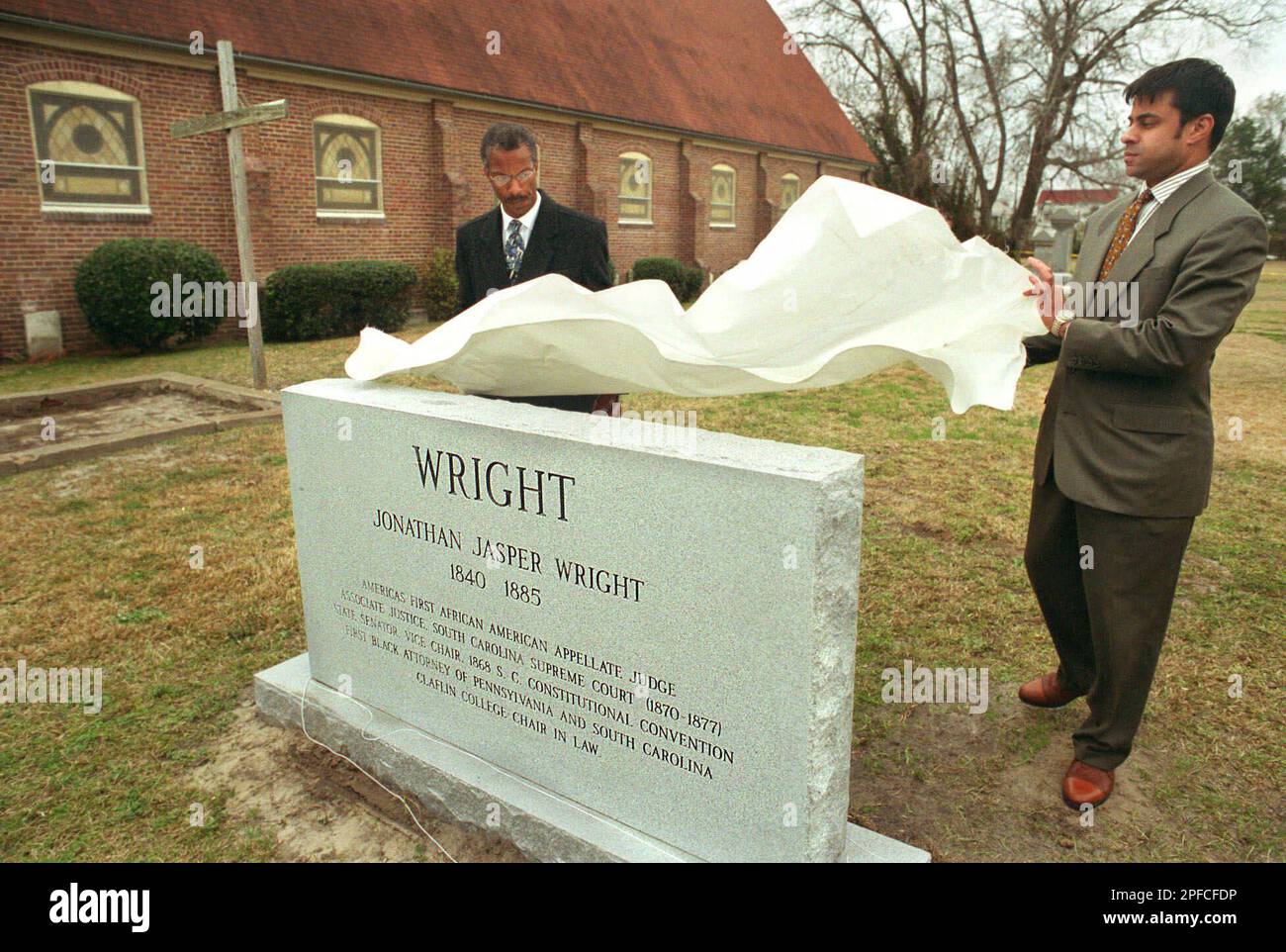 Attorney Kenneth Edwards, left, and Assistant City Attorney Carl Stent, right, unveil a ...