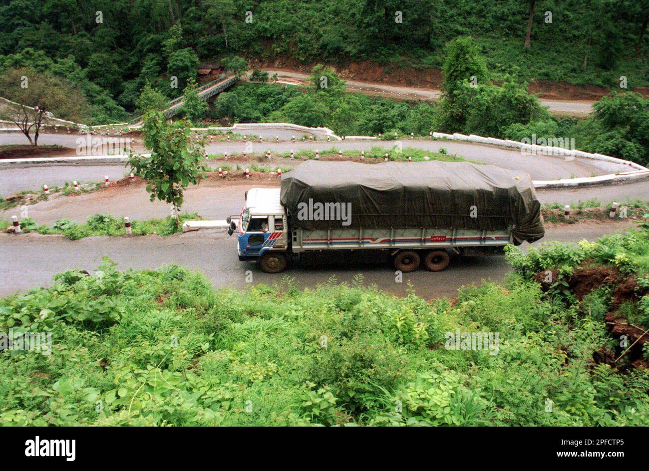 A truck makes its way down a winding highway linking Lashio and ...