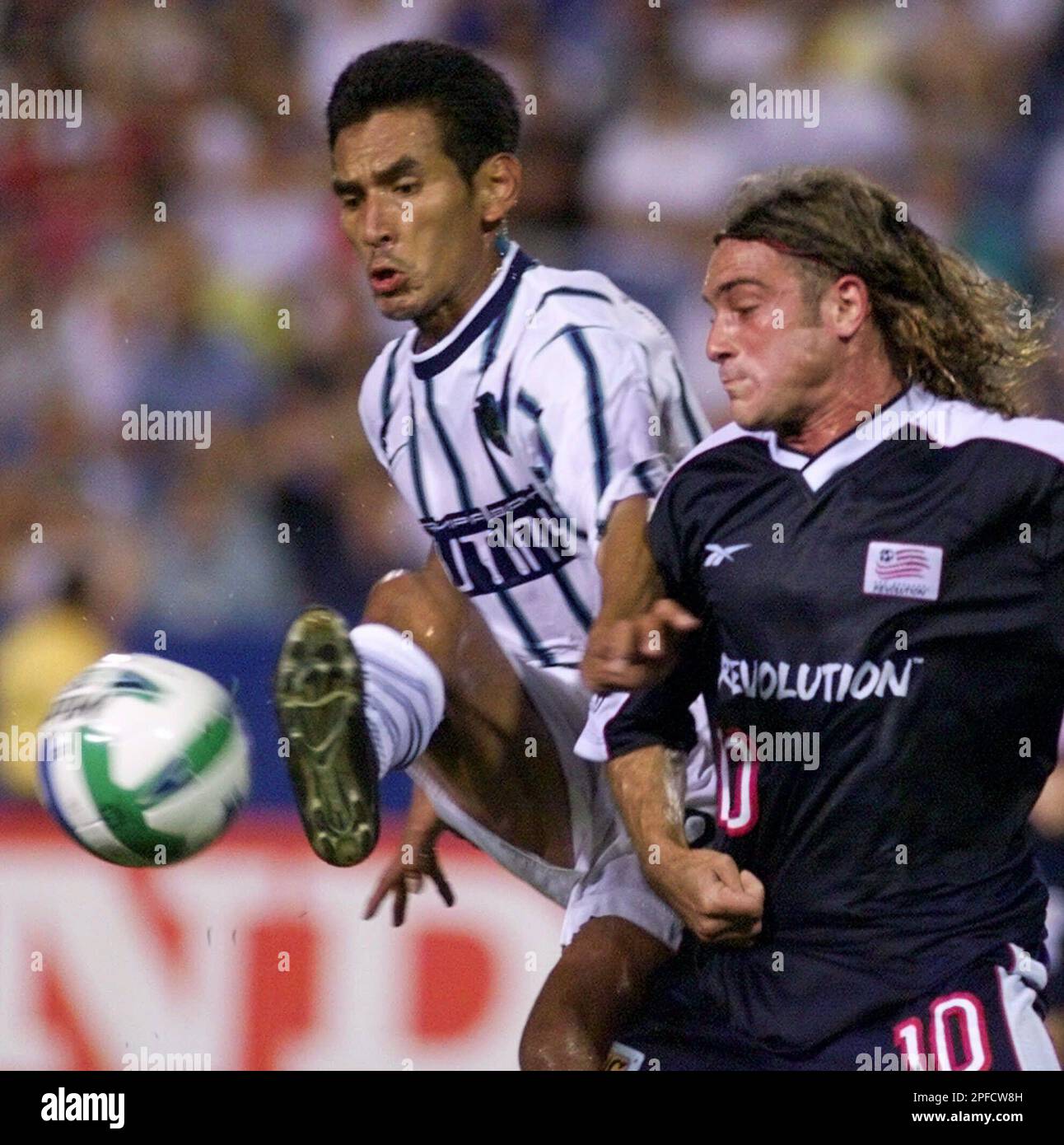 Tampa Bay Mutiny's Raul Diaz Arce, left, kicks the ball away from New ...