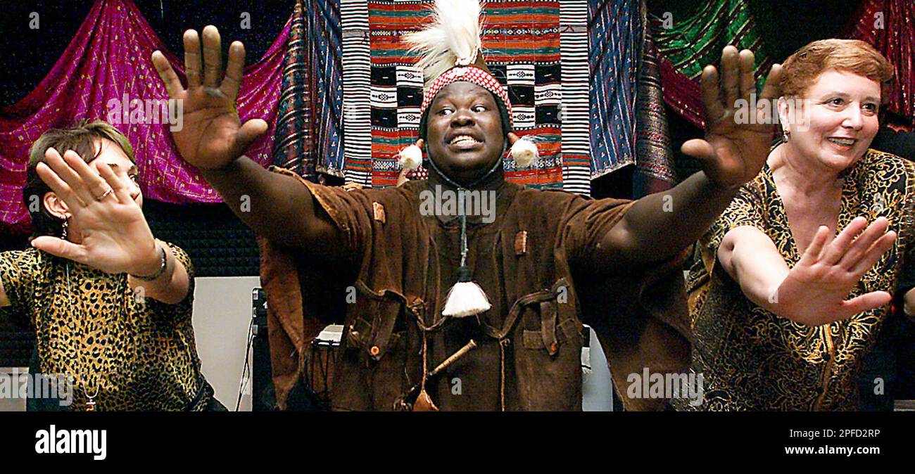 West African master drummer Madou Dembele gives a quick dance lesson to ...
