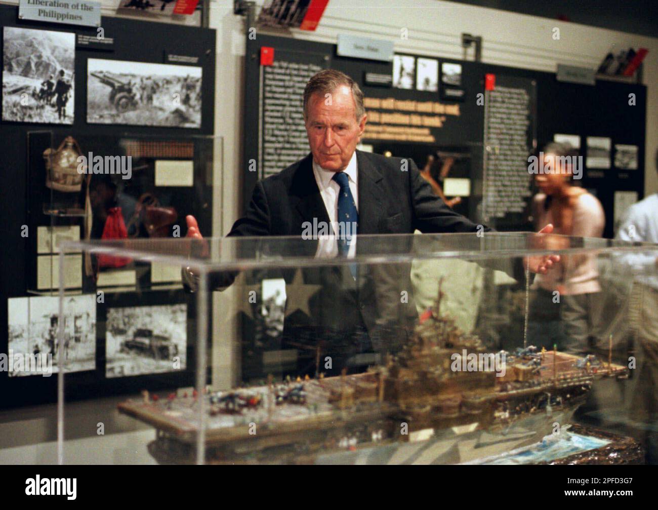 Former President George H.W. Bush takes a look at a model of the World ...