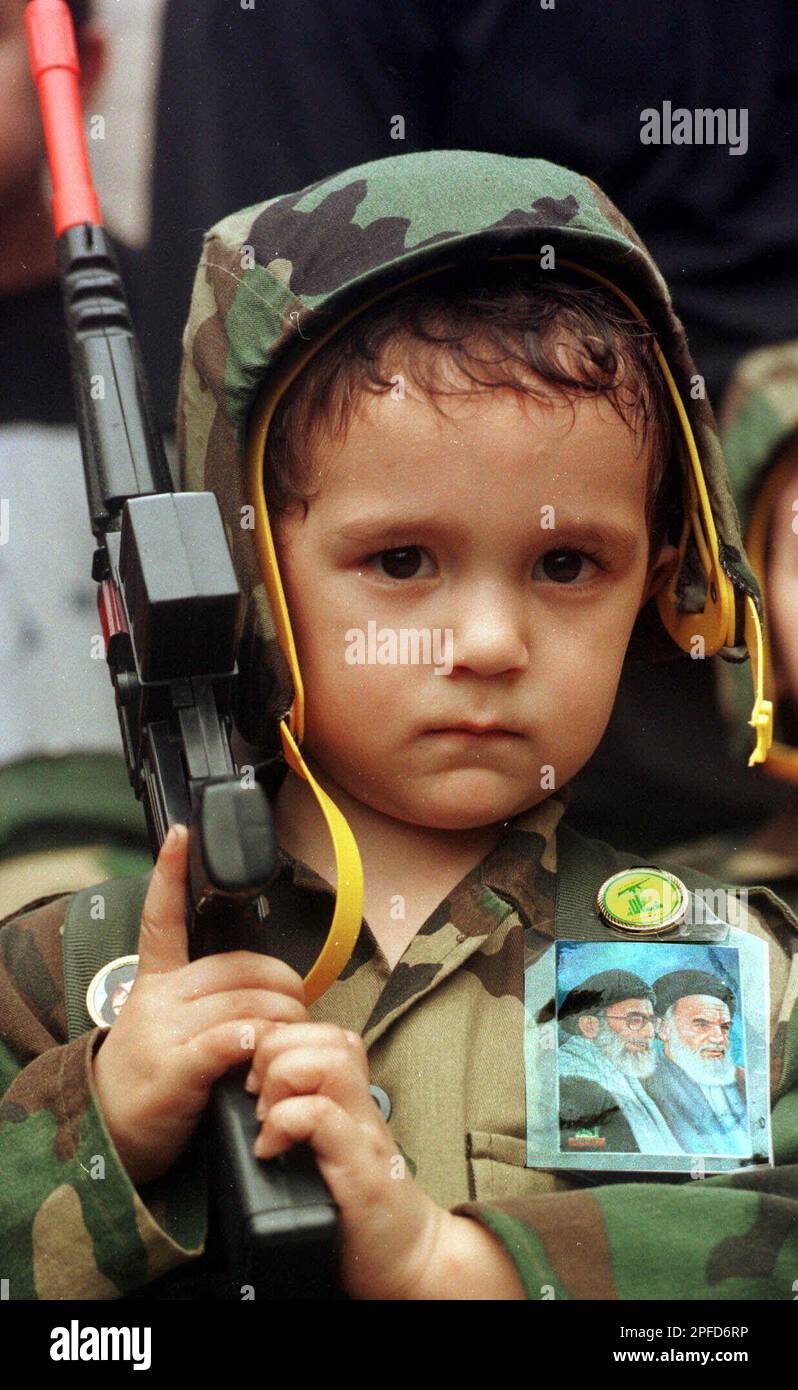 Wearing portraits of the Iranian leaders Khamanei and Khomeini and a ...