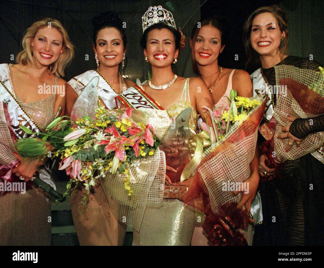 A beeming Miss Varalat Suwanalat of Thailand, center, the winner of the ...