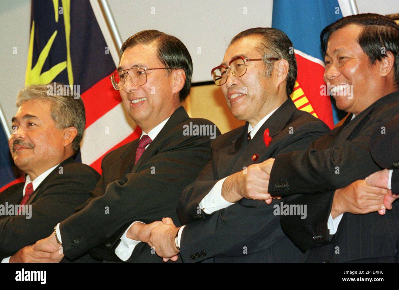 Representatives of the ASEAN countries join their hands during a ...