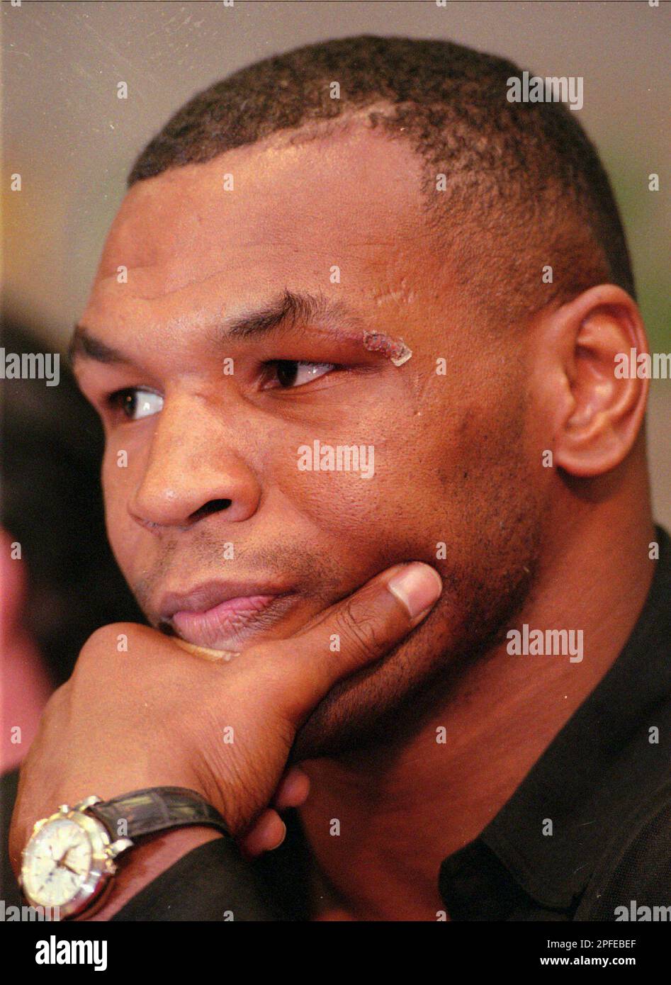 Heavyweight boxer Mike Tyson listens to a question during a news ...