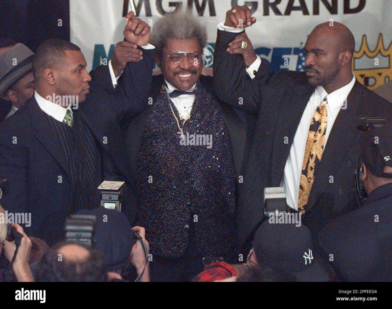 Heavyweight boxer Mike Tyson, left, appears at a news conference to ...