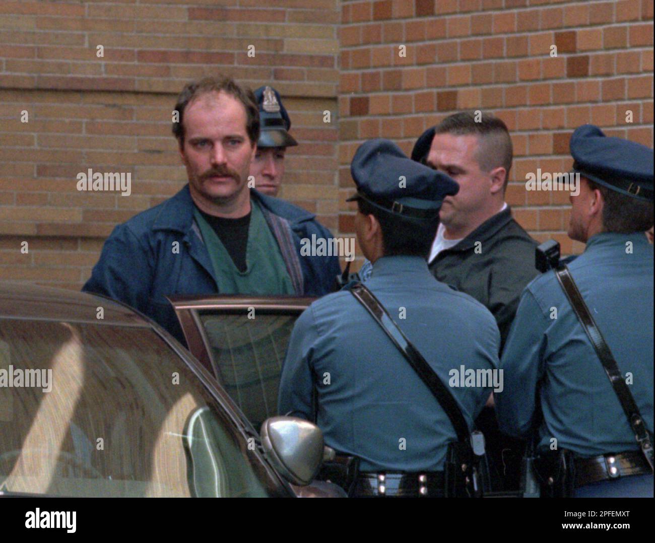 Convicted murderer David Clark, left, is walked through a line of ...
