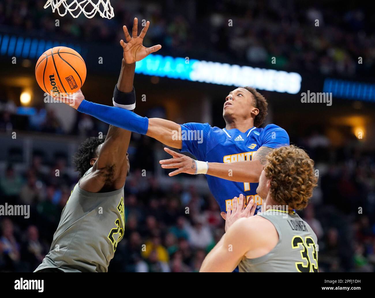 UC Santa Barbara guard Josh Pierre-Louis, center, drives to the basket ...