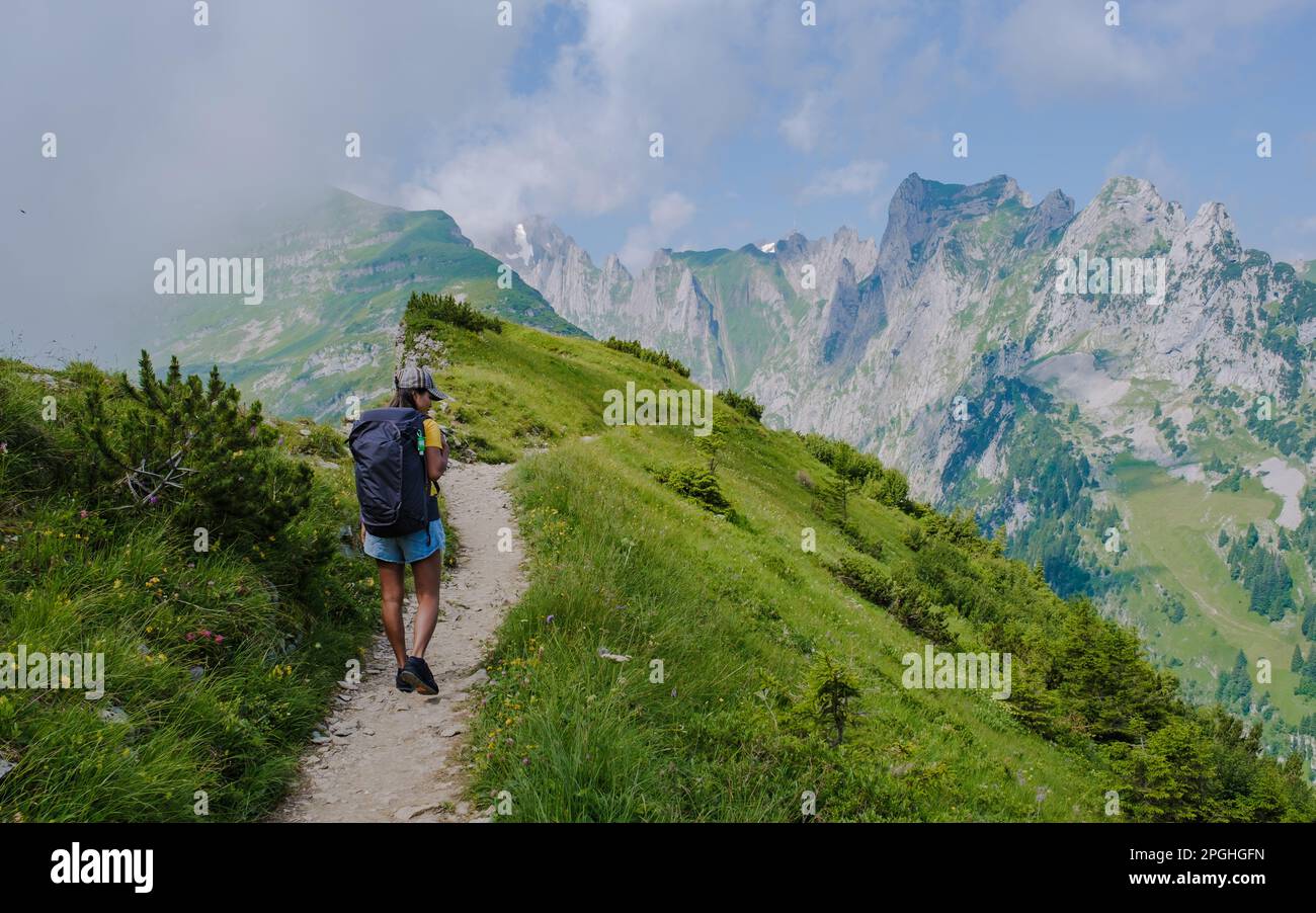 Asiatische Frauen wandern im Sommerurlaub in den Schweizer Alpen mit ...