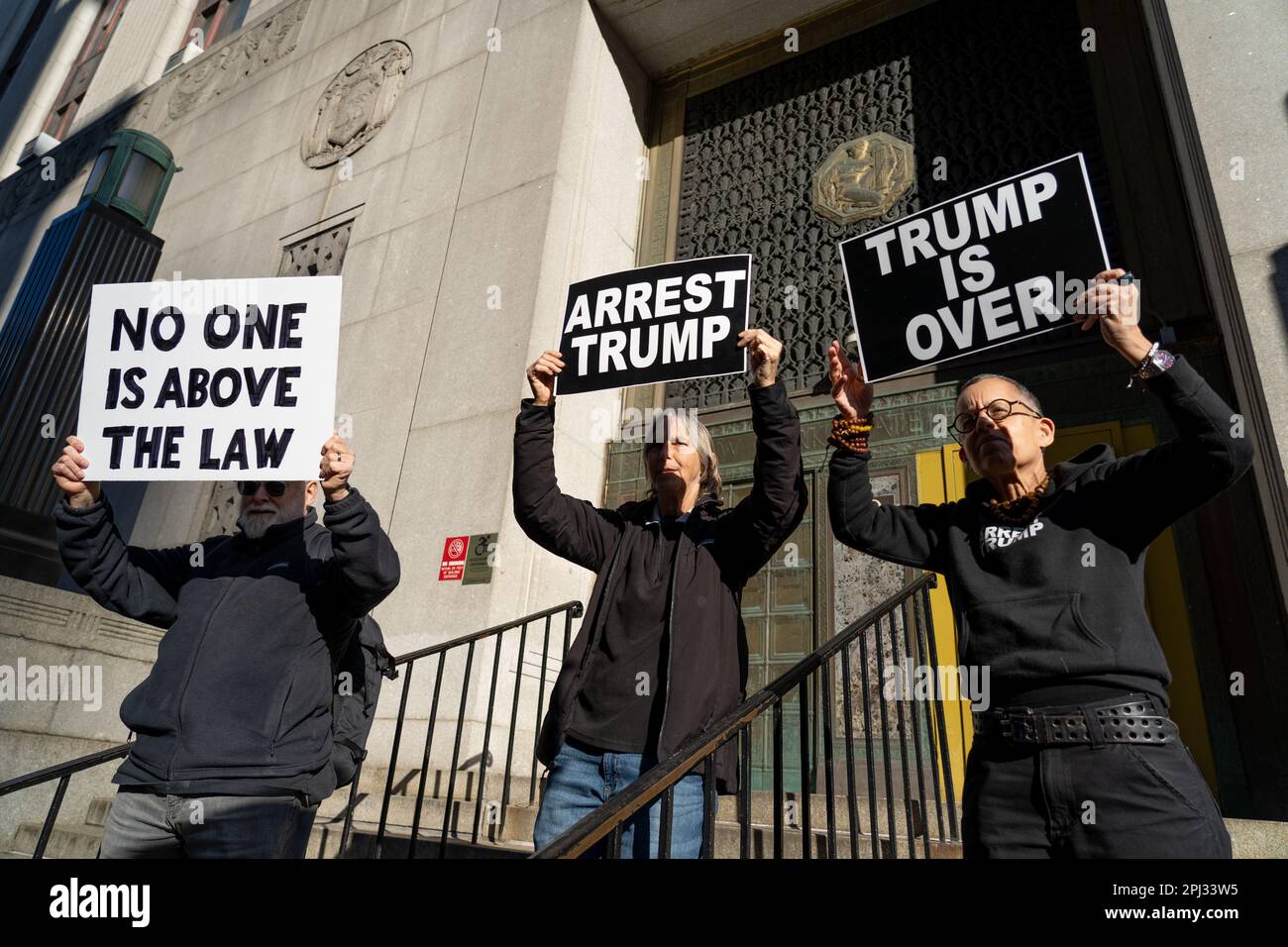 Anti-Trump-Demonstranten halten Schilder vor dem Manhattan Strafgericht ...