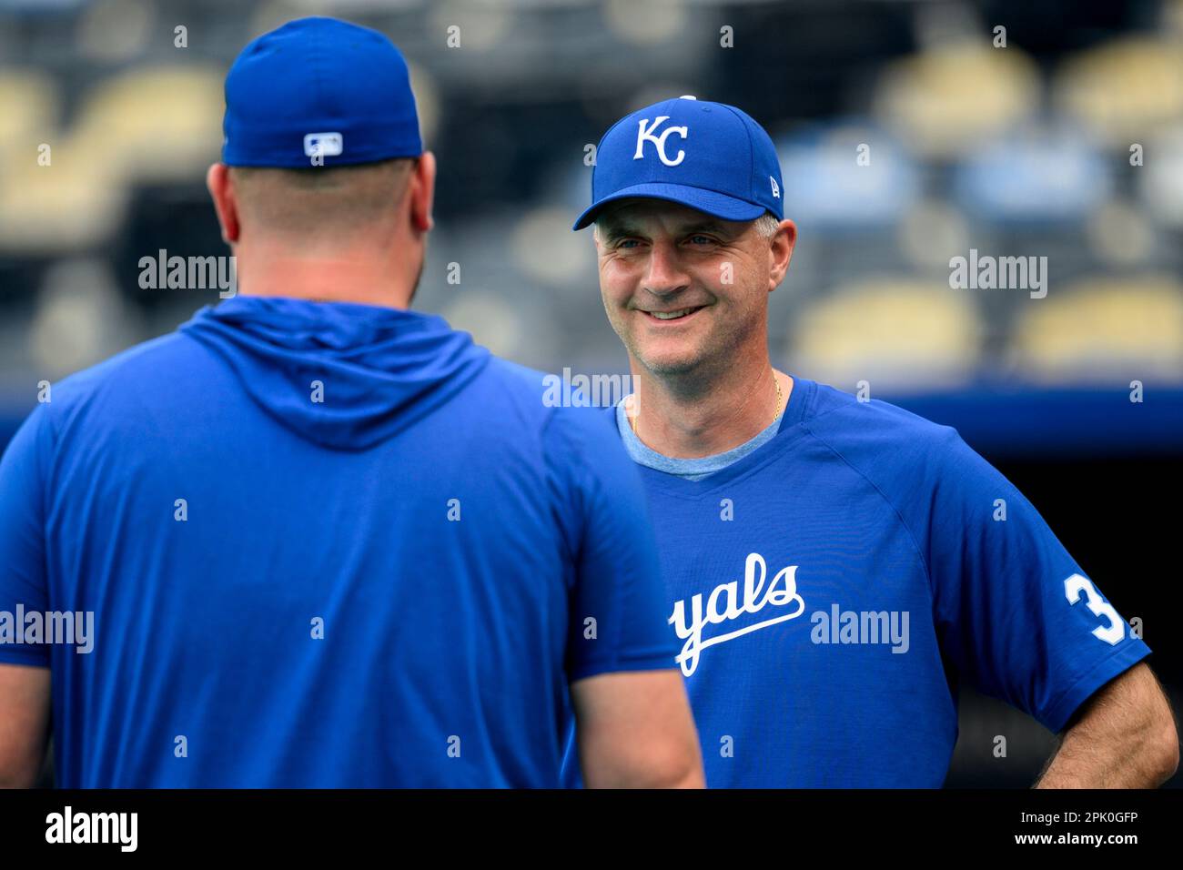 Kansas City Royals manager Matt Quatraro talks with a member of the ...